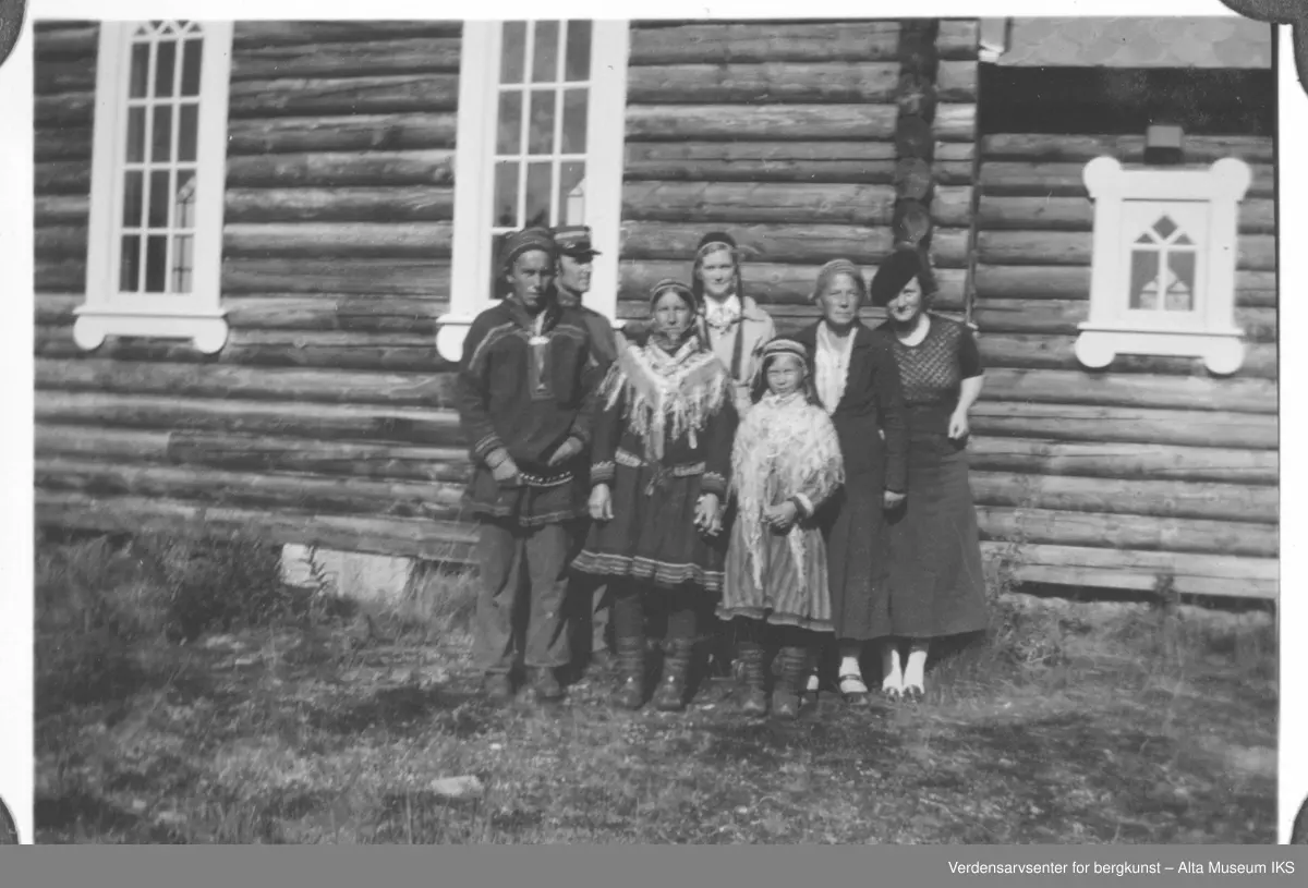 gruppe av menn, kvinner og barn utenfor Masi kapell, noen bærer kofte ...